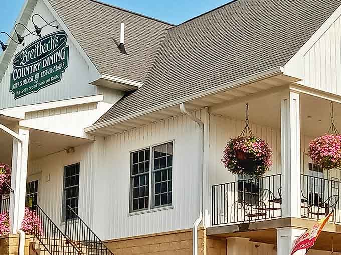 Hanging flower baskets add splashes of color against Breitbach's pristine white siding, embodying that perfect "grandma's house" welcome.