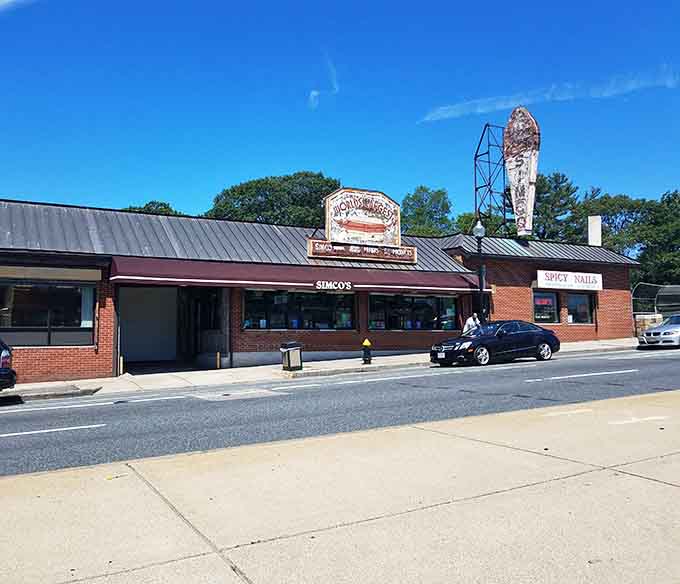 The full view of Simco's on a perfect blue-sky day, with that giant hot dog sign standing tall like a delicious landmark.