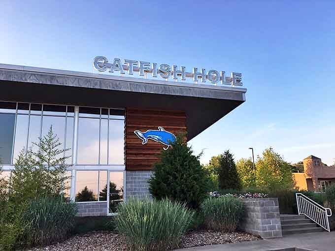 The Catfish Hole's modern exterior with rustic wood accents stands like a beacon of comfort food promise in Alma's landscape.