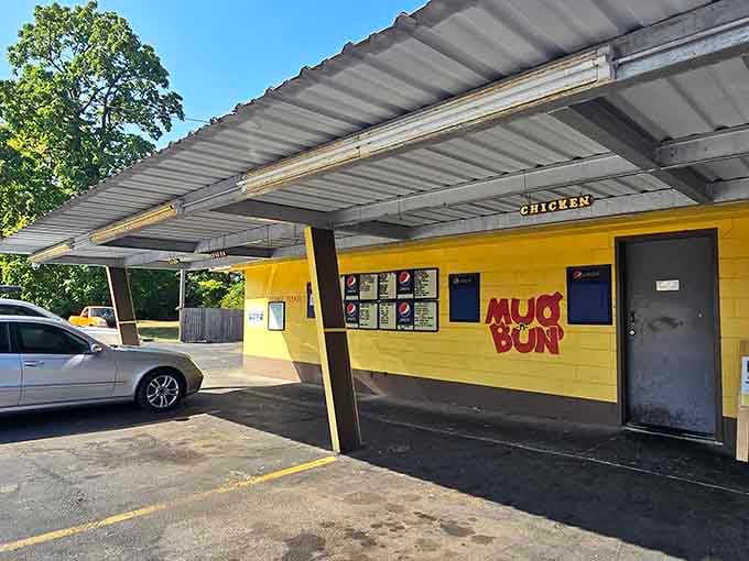 A sunny yellow drive-in restaurant with vintage appeal, where covered parking meets classic American comfort food in the most welcoming way possible.