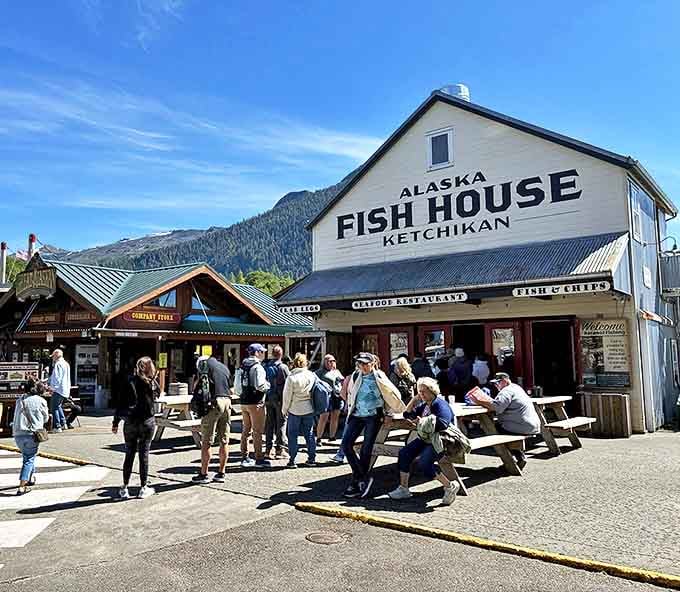 The quintessential Alaskan seafood experience stands proudly against a backdrop of mountains, where picnic tables and happy diners signal you've found the real deal.