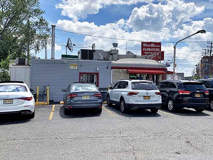 The iconic red and white signage of White Manna stands out against the sky like a beacon calling all burger enthusiasts home.