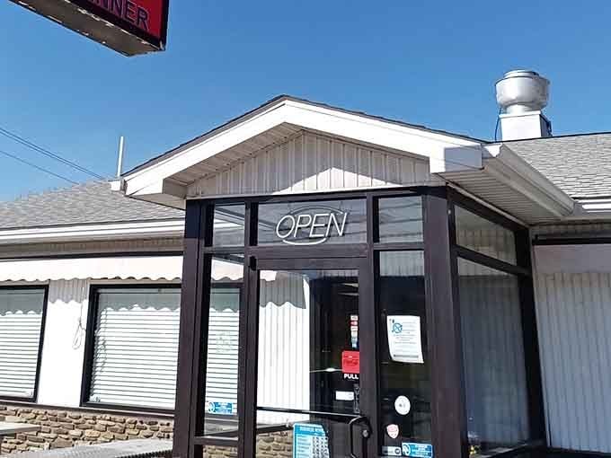 The neon "OPEN" sign beckons like an old friend, promising comfort food that'll hug your insides better than your favorite sweater.