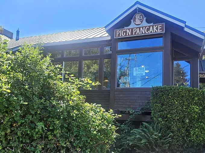 The wood-shingled exterior promises comfort food within, surrounded by coastal greenery that says "Oregon" without saying a word.