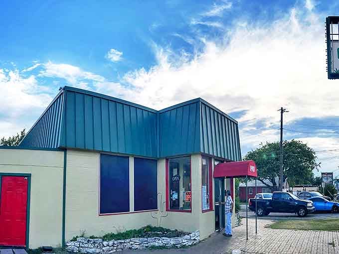 The unassuming green-roofed exterior of Enchiladas Y Mas stands as a beacon of hope for authentic Tex-Mex seekers amid Austin's sea of pretenders.