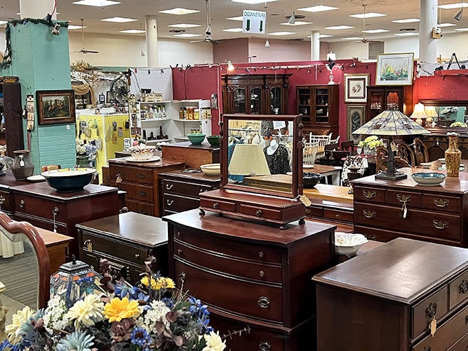 Furniture heaven! Rich mahogany dressers and vanities await new homes, each piece telling silent stories of dinner parties past and family gatherings long forgotten.