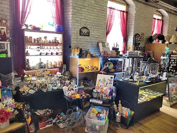 Pink curtains frame this wonderland of collectibles like a theatrical stage where porcelain figurines and vintage trinkets are the stars of the show.