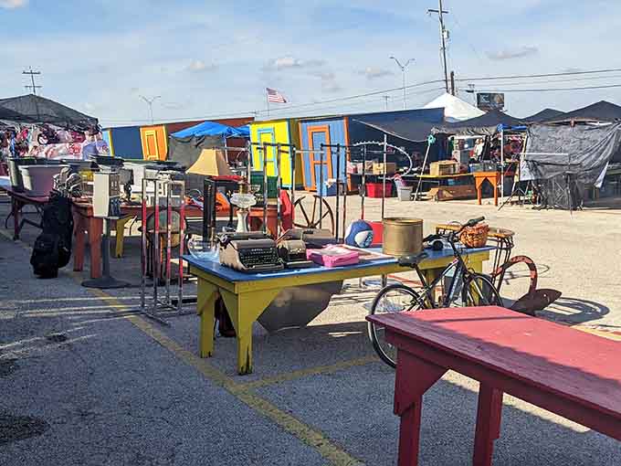 Colorful outdoor tables showcase random treasures like old typewriters and bicycles, proving one person's attic cleanout is another's weekend jackpot.