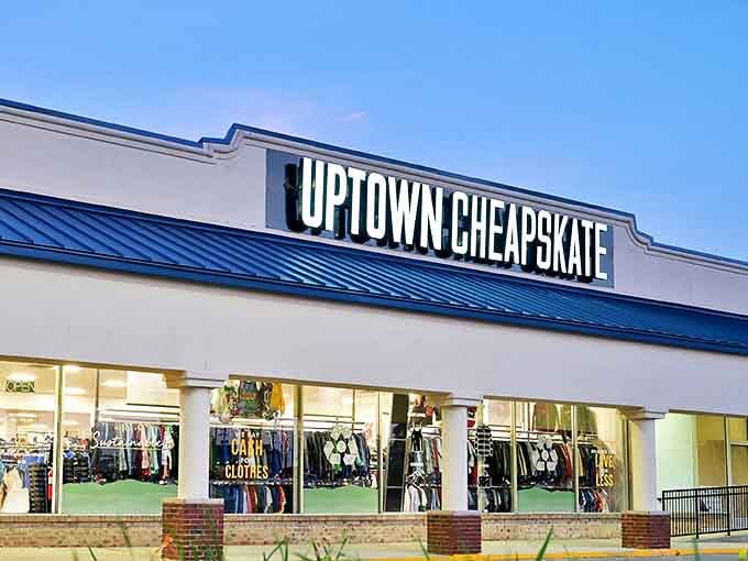 The blue-trimmed facade of Uptown Cheapskate stands like a beacon for bargain hunters. Fashion salvation awaits behind those gleaming windows.