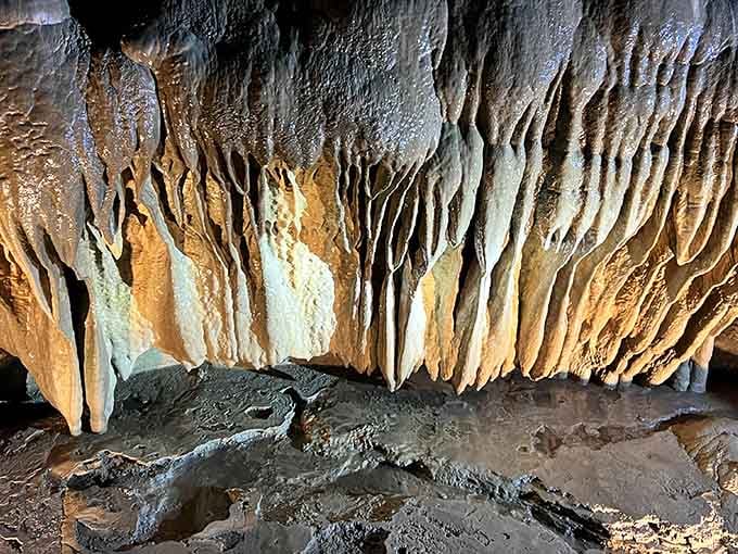 Stone draperies hang like nature's curtains, each fold representing thousands of years of patient, dripping artistry.