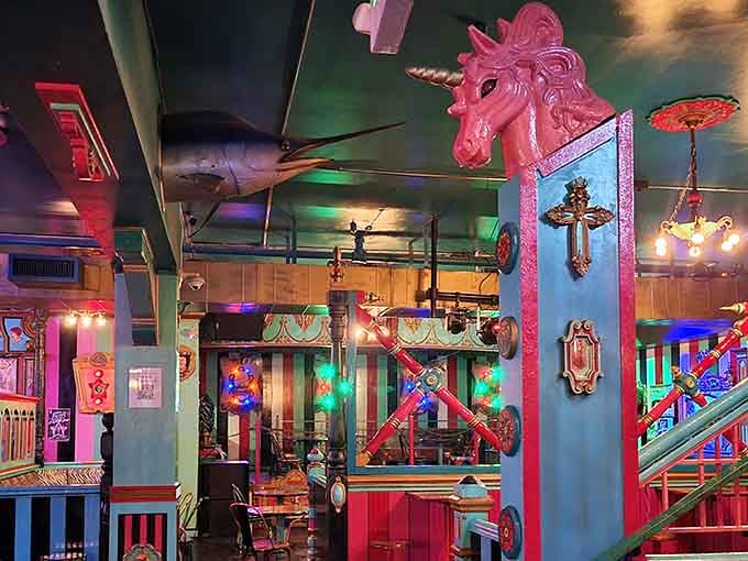 That pink unicorn head isn't just decoration, it's basically the bar's spirit animal watching over the glorious chaos below.