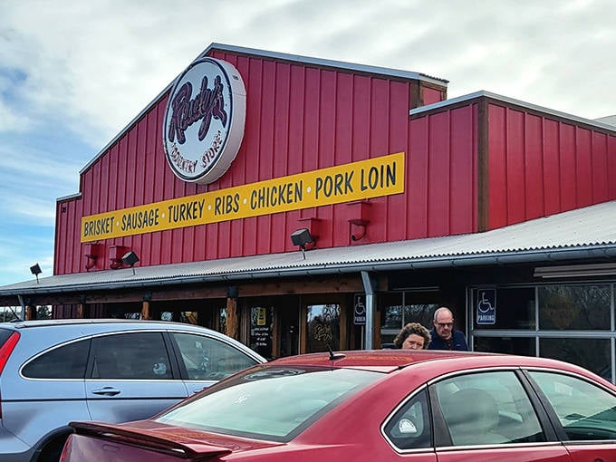 The iconic red exterior of Rudy's beckons like a barbecue lighthouse, promising smoky treasures within those rustic wooden walls.