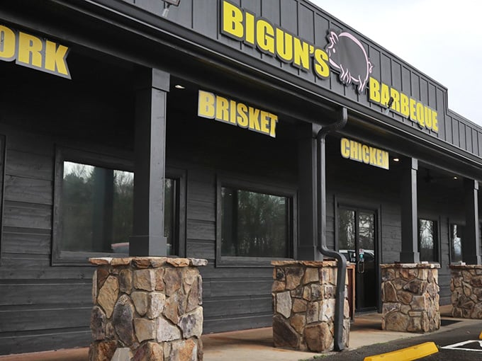 Stone columns and metal siding frame the entrance where barbecue dreams become delicious, smoky reality for hungry visitors.