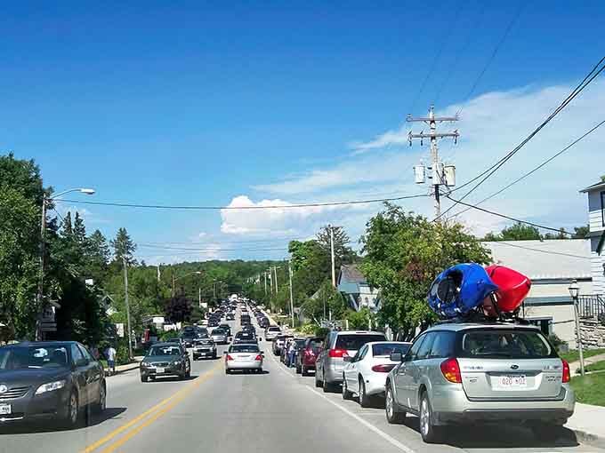 Main Street buzzes with that perfect small-town energy where kayaks on car roofs are considered high fashion.