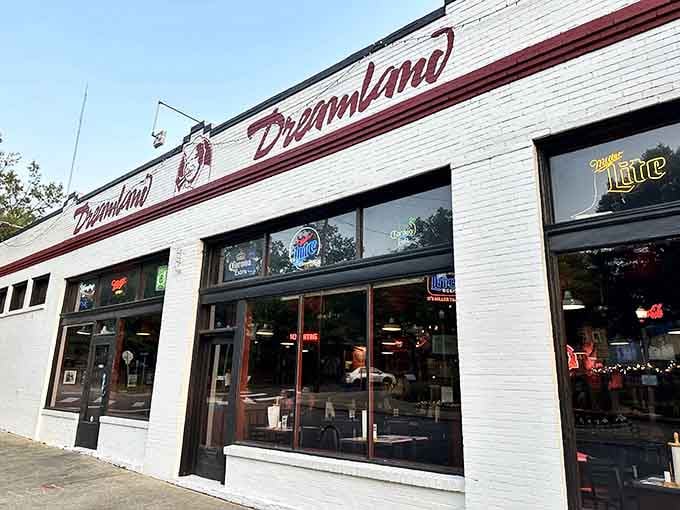 That white exterior with red lettering isn't fancy, but it's been calling barbecue pilgrims home for decades.