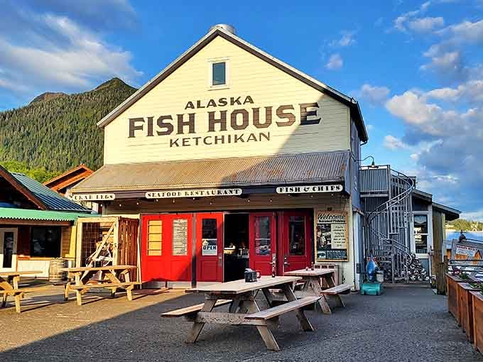 The quintessential Alaskan seafood experience stands proudly against a backdrop of mountains, where picnic tables and happy diners signal you've found the real deal.