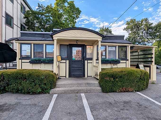 That cream-colored exterior with its charming peaked entrance isn't trying to impress anyone, and that's exactly why it does.