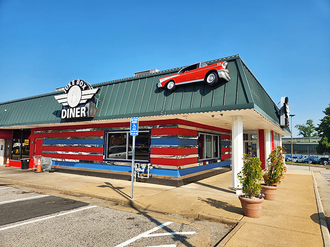 That's a classic car literally climbing the roof, proving this diner takes the fifties theme seriously enough to defy gravity.