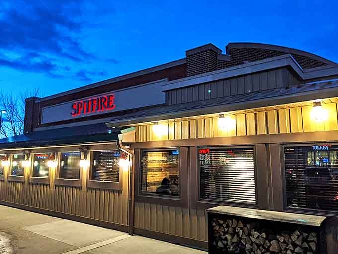 As dusk approaches, Spitfire's illuminated exterior transforms into a glowing sanctuary for the barbecue faithful.