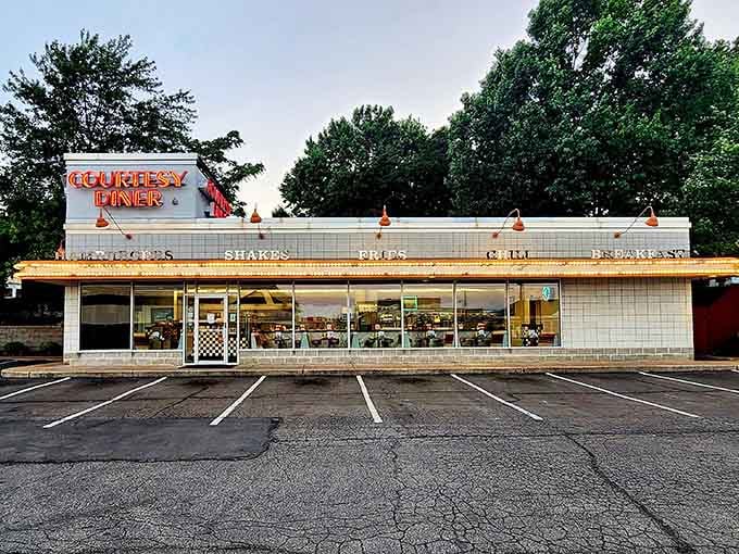 Dawn breaks over diner paradise. This classic white-tiled time capsule stands ready for another day of slinging hash browns and flipping pancakes to perfection.
