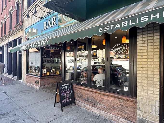 That green awning is like a lighthouse guiding hungry souls to cannoli paradise on Hanover Street.