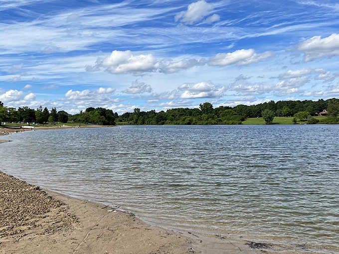 The sandy shoreline of Big Seven Lake invites swimmers and sunbathers to enjoy Michigan's hidden aquatic playground.