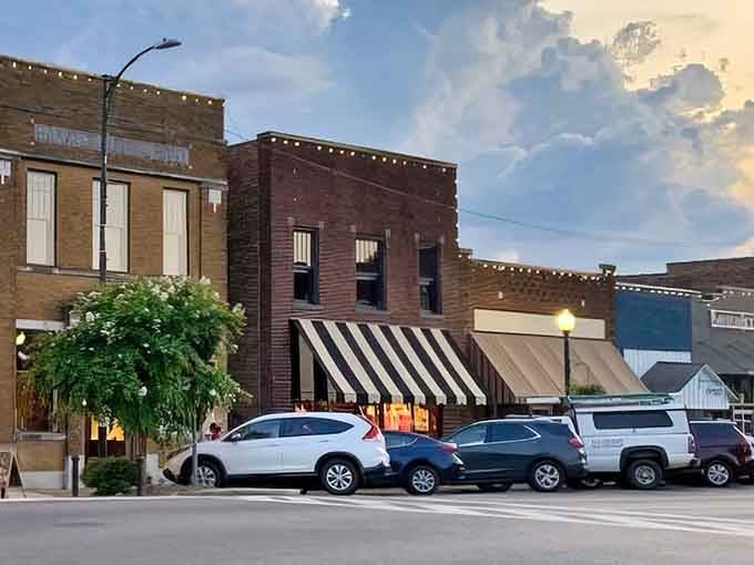 Downtown New Albany at dusk, where string lights twinkle above historic brick buildings like a small-town version of Times Square&mdash;minus the chaos and plus all the charm.