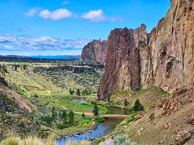 The Crooked River carves through the canyon like a liquid sapphire ribbon, reflecting those magnificent volcanic formations above.