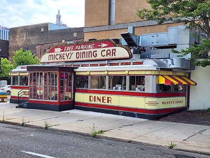 That red and yellow art deco exterior isn't just pretty, it's a neon-lit time capsule on wheels.
