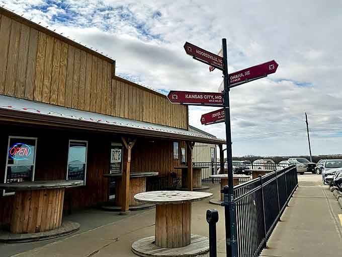 Directional signs outside Round the Bend Steakhouse highlight its strategic location between major Midwestern cities, drawing visitors from all directions.