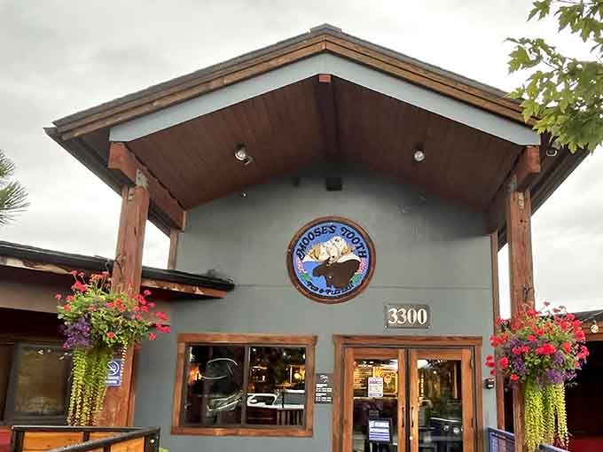 The rustic charm of Moose's Tooth welcomes hungry Alaskans with its distinctive red walls and wooden beams&mdash;architectural proof that great pizza doesn't need fancy digs.