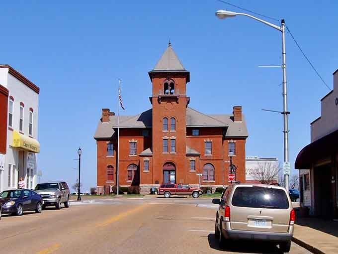 The Madison County Courthouse stands proudly in brick-and-mortar majesty, a testament to when public buildings were architectural statements, not just functional boxes.