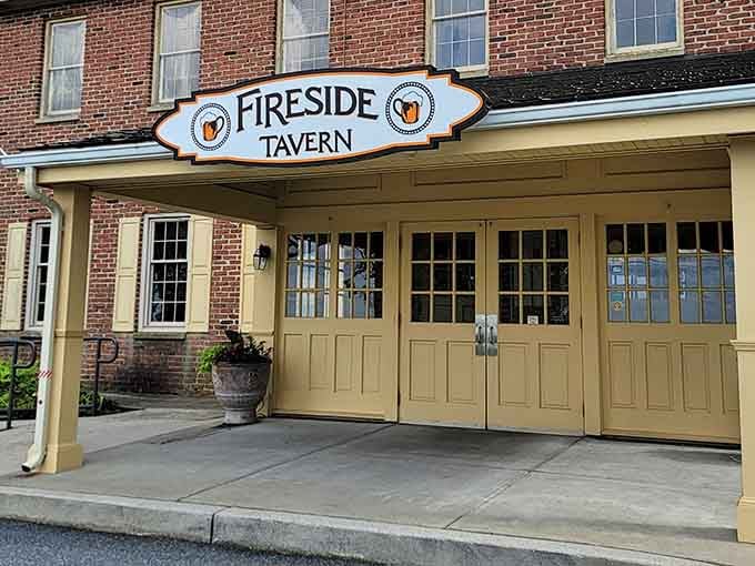 A closer view of Fireside Tavern's distinctive sign and entrance, where Lancaster County culinary magic awaits behind those warm yellow doors.