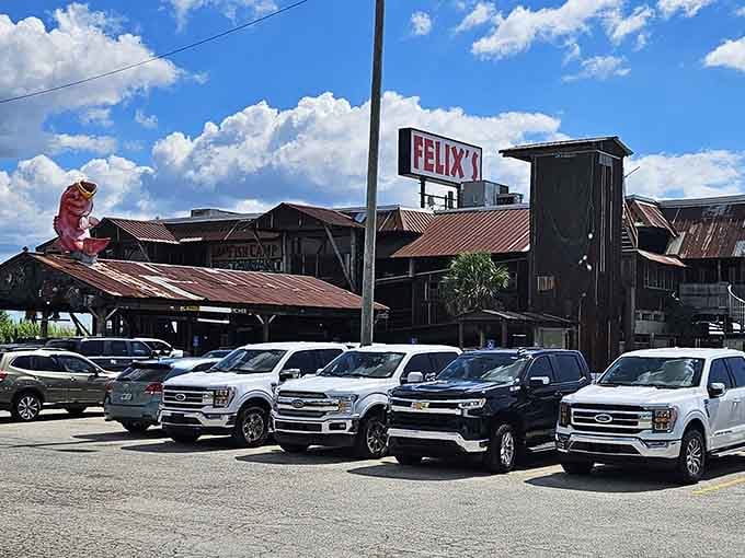 The iconic giant red fish perches atop Felix's rustic roof, greeting hungry visitors under Alabama's brilliant blue skies.
