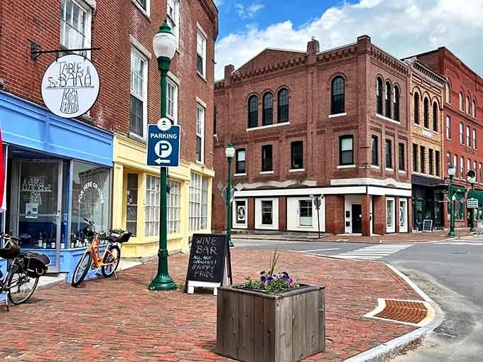 A charming corner of downtown Gardiner, where historic brick buildings house local businesses along brick-paved sidewalks under Maine's blue skies.