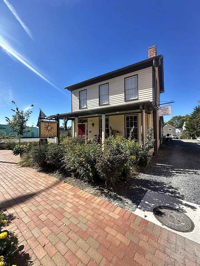 Brick pathways and thoughtful landscaping frame the entrance, hinting at the care and attention you'll find inside.