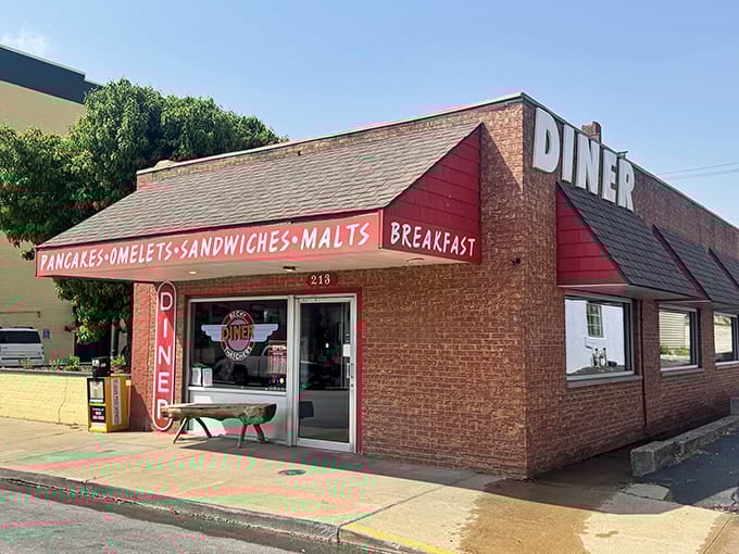That red brick exterior and vintage signage announce breakfast is serious business here, like a beacon for hungry souls.