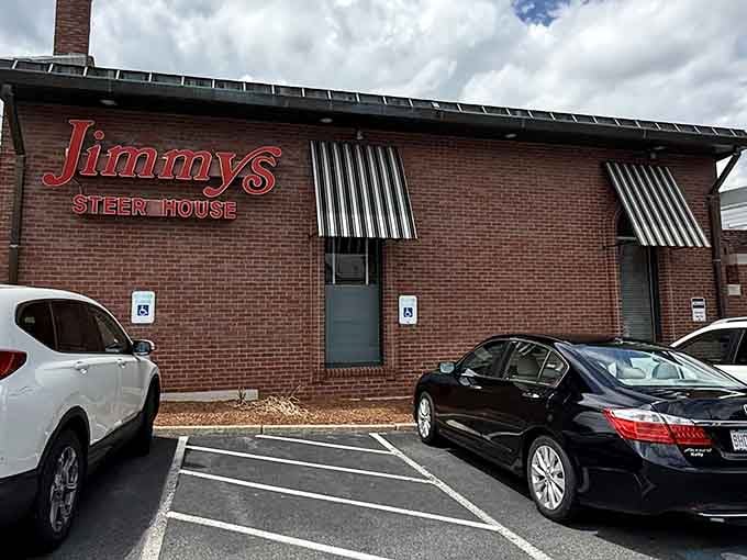 The iconic red signage of Jimmy's Steer House stands out against the brick exterior, like a beacon calling hungry carnivores home to their meaty sanctuary.