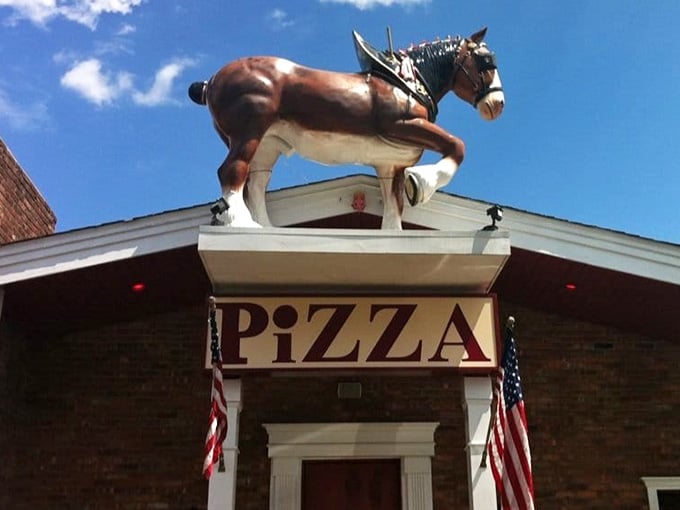 Majestic and determined, Kinchley's rooftop horse seems ready to gallop off with the "PIZZA" sign, though locals would stage a revolution if either disappeared.
