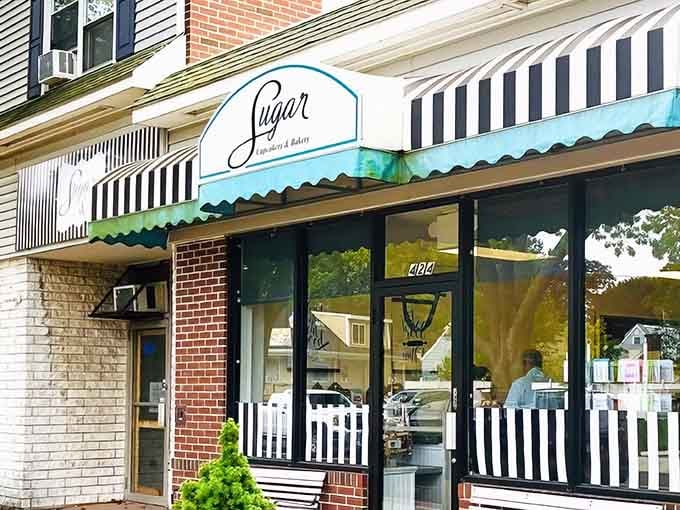 That turquoise and black striped awning isn't just charming, it's like a beacon calling you toward buttercream bliss and cake-induced happiness.