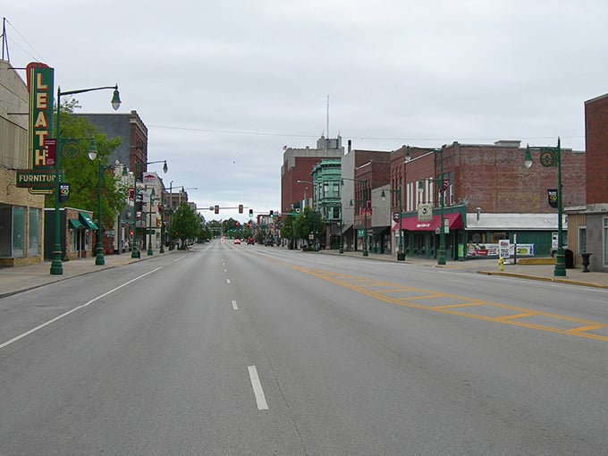 Main Street's quiet charm belies the vibrant community life within these storefronts, where vintage neon signs and classic lampposts create a Norman Rockwell scene with modern affordability.