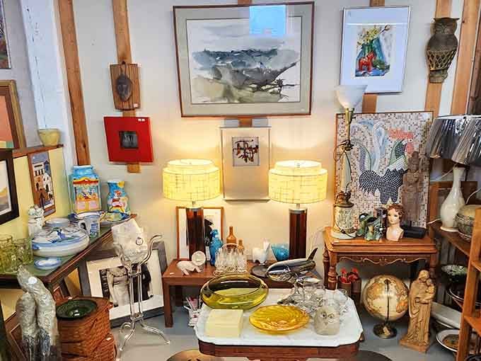 A thoughtfully arranged vignette showcases maritime artwork, vintage lamps, and decorative pieces that tell stories of New England's rich heritage.