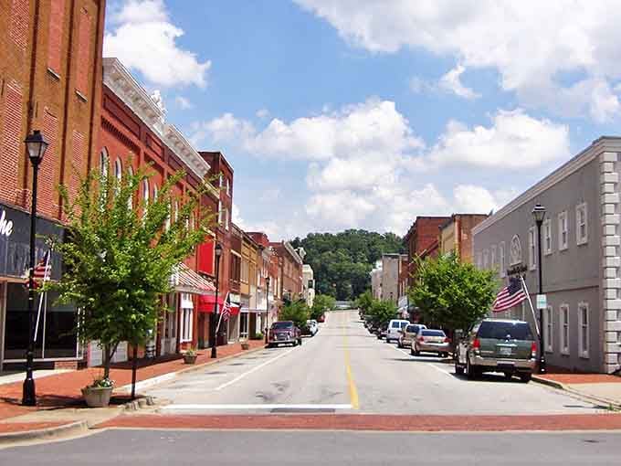 Tree-lined streets and brick storefronts define Greeneville's walkable downtown, where American flags flutter alongside locally-owned businesses that welcome newcomers with Southern hospitality.