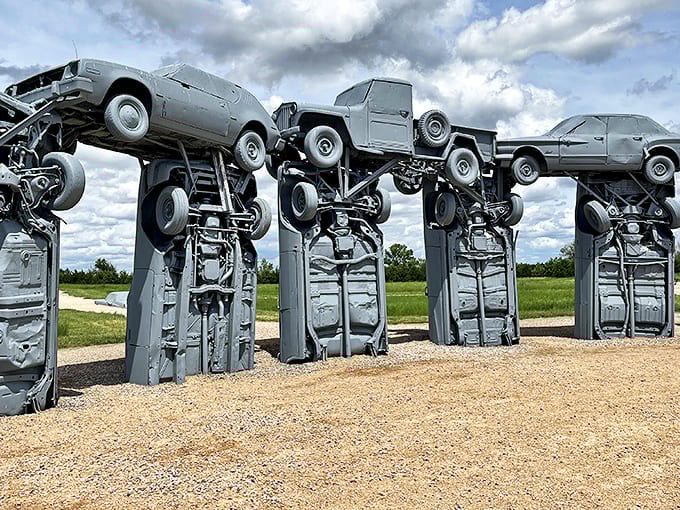 The automotive Stonehenge rises from the Nebraska prairie like a Detroit-inspired dream, where classic American cars reach for the sky instead of cruising highways.