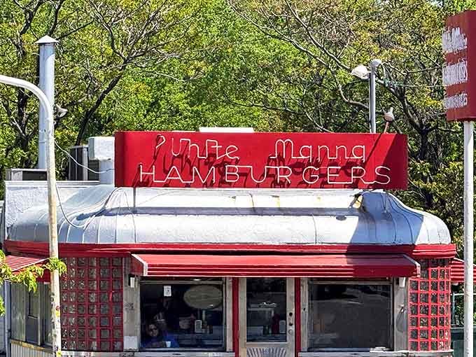 The iconic red and white signage of White Manna stands out against the sky like a beacon calling all burger enthusiasts home.