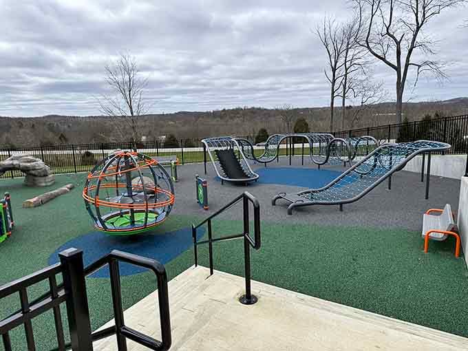 Rolling hills frame this accessible play zone where every kid finds their perfect challenge level.