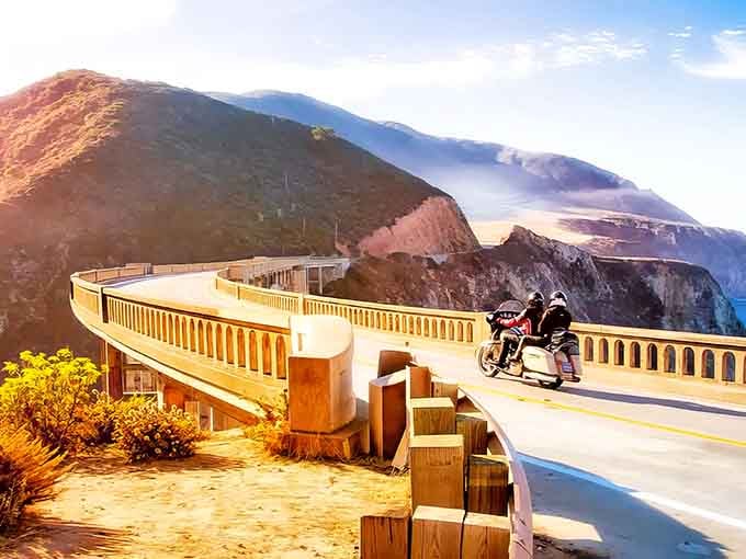The Bixby Creek Bridge stands as Highway 1's crown jewel, where motorcyclists pause to contemplate the perfect marriage of human ingenuity and natural splendor.