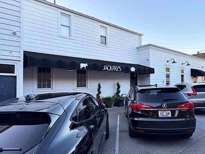 That classic black awning and white clapboard exterior practically whispers "Louisville institution" without saying a word at all.