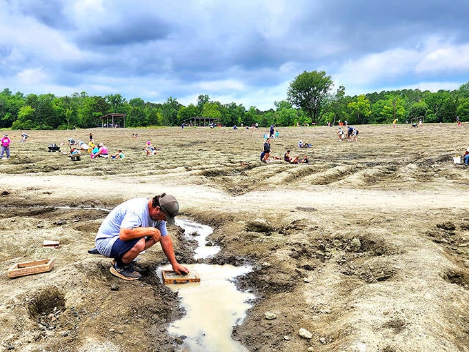 Serious diamond hunters in action! This isn't a beach day &ndash; it's a treasure hunt where muddy knees are badges of honor and puddles might hide gemstones.