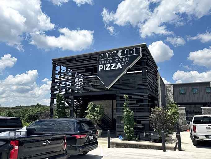 That modern industrial exterior hides one of the most delightfully bizarre dining experiences in the Texas Hill Country.